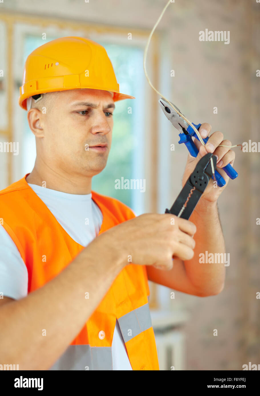 Man works with electrical wires in the new house Stock Photo - Alamy