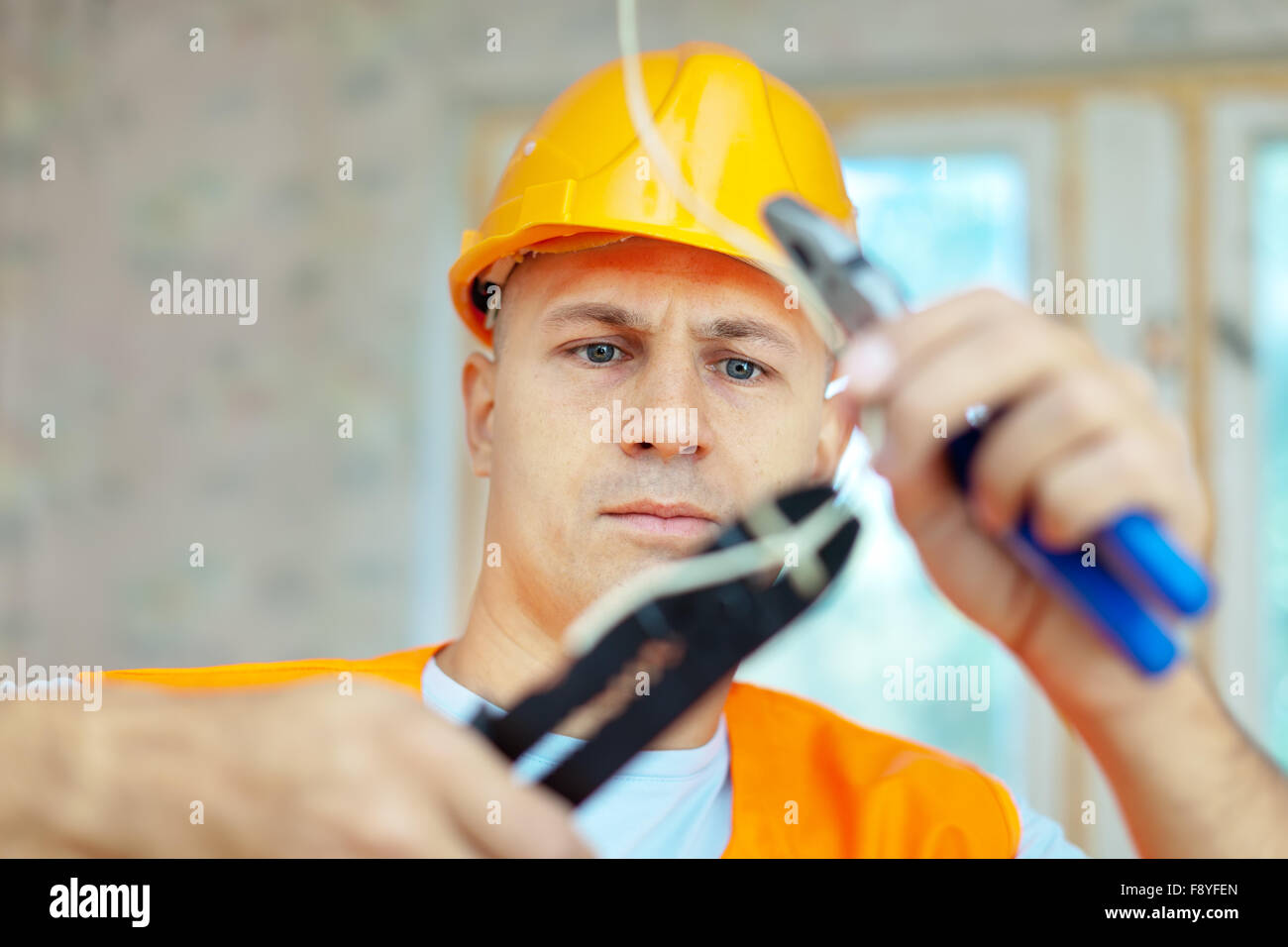 electrician installing electricity in a new house Stock Photo - Alamy