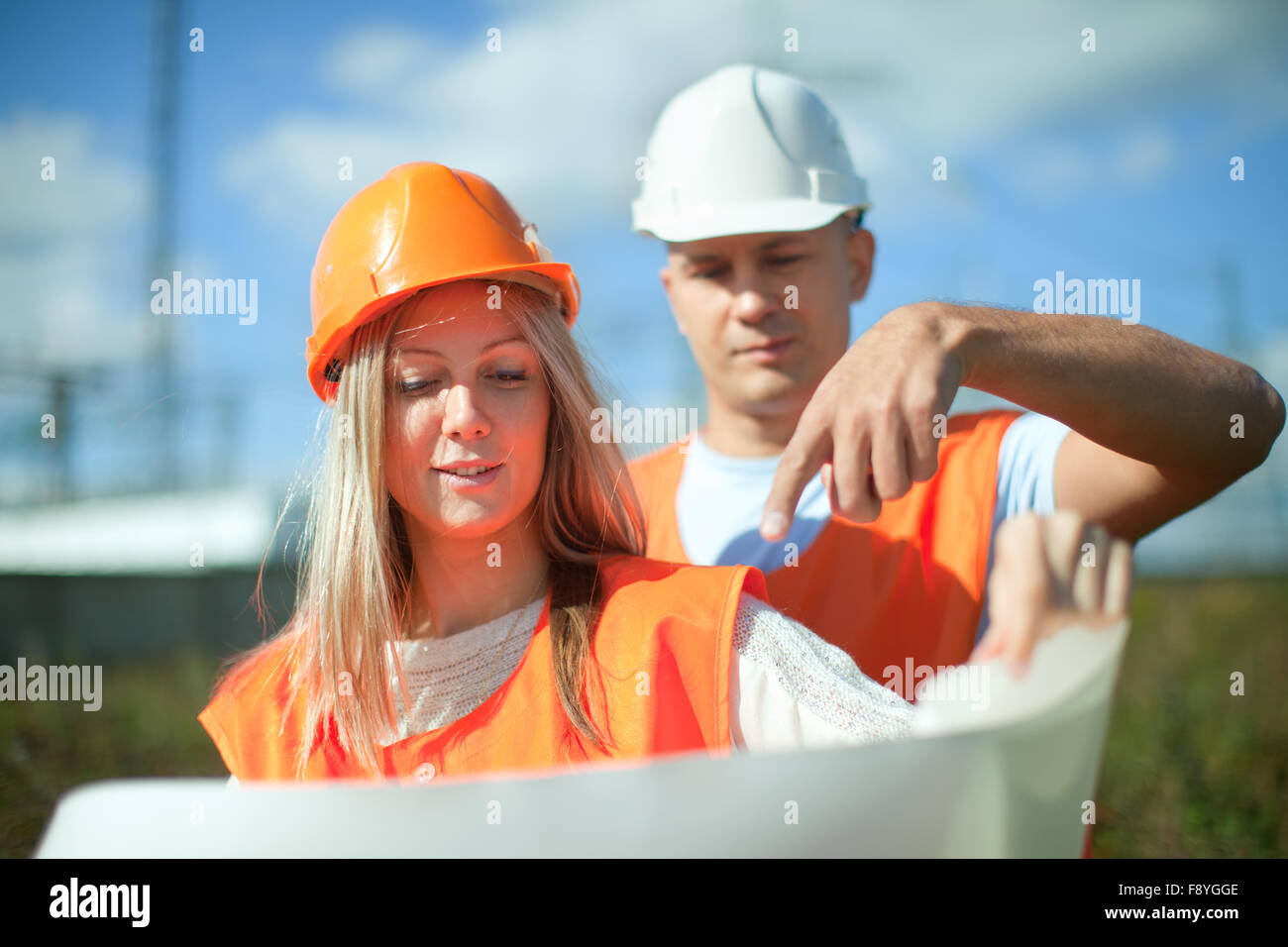 Portrait of two builders standing at electric power plant Stock Photo ...