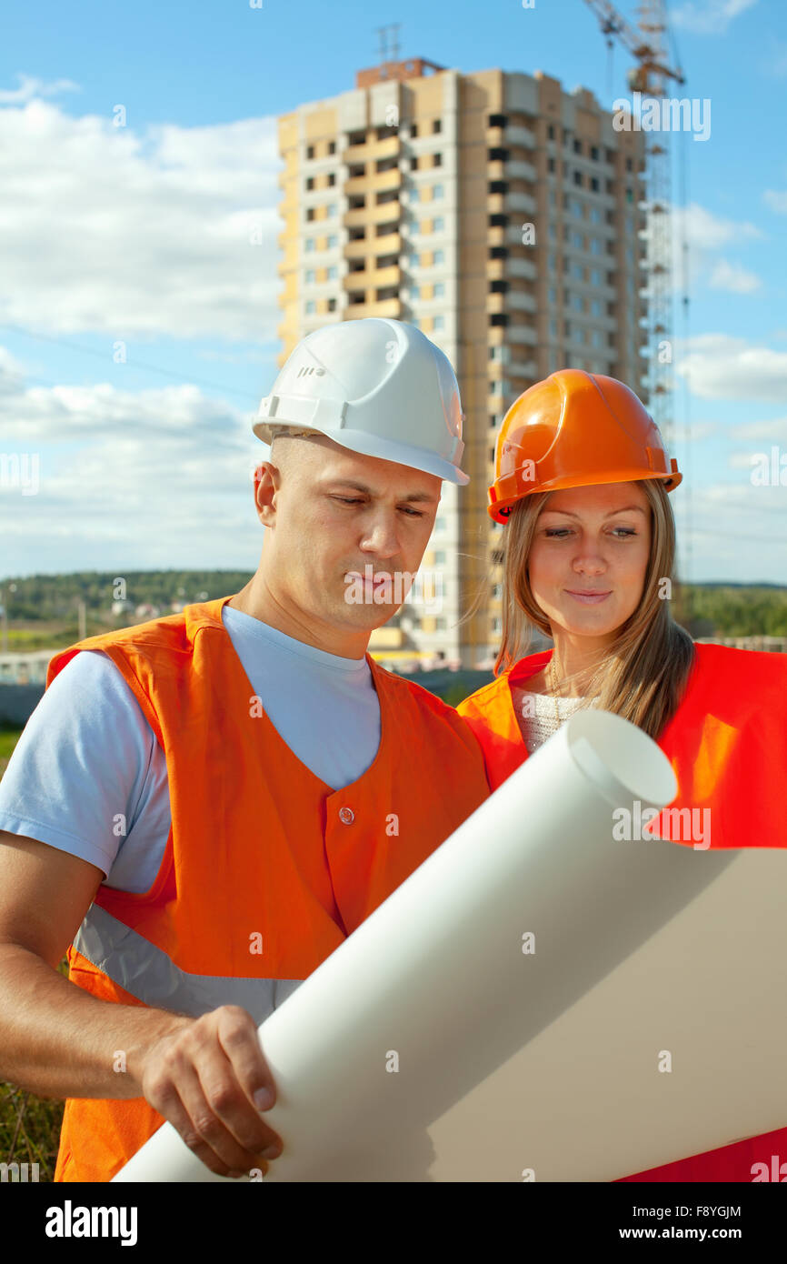 Portrait of two builders works at construction site Stock Photo - Alamy