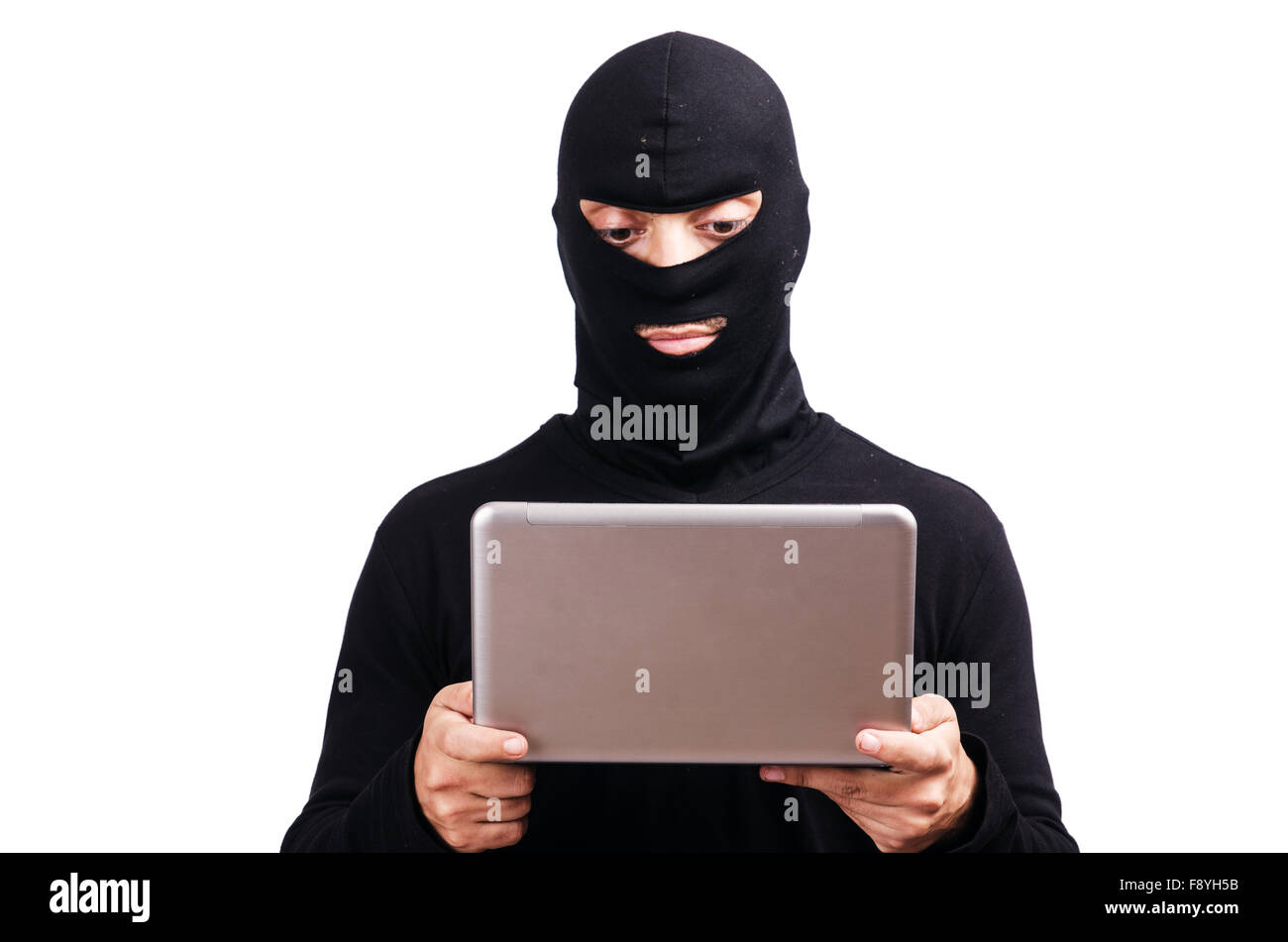 Hacker with computer wearing balaclava Stock Photo - Alamy