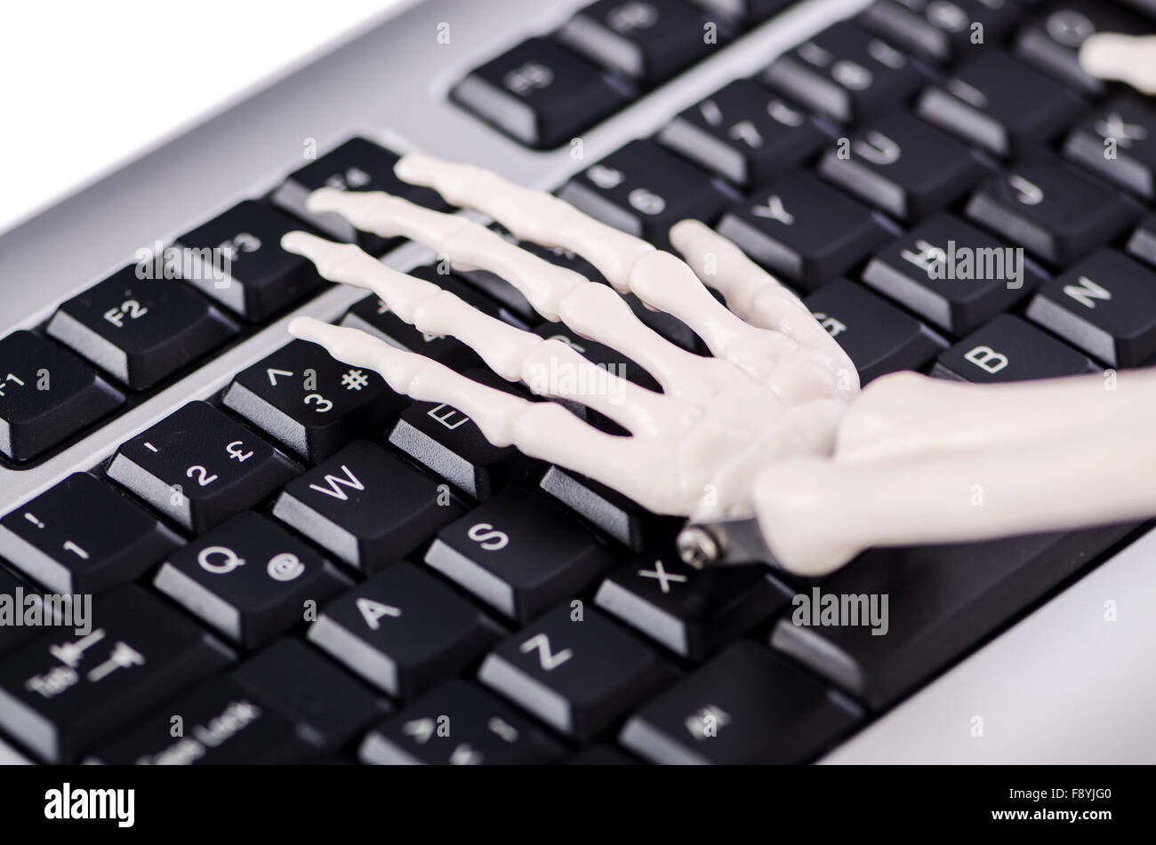 Skeleton working on the keyboard Stock Photo - Alamy