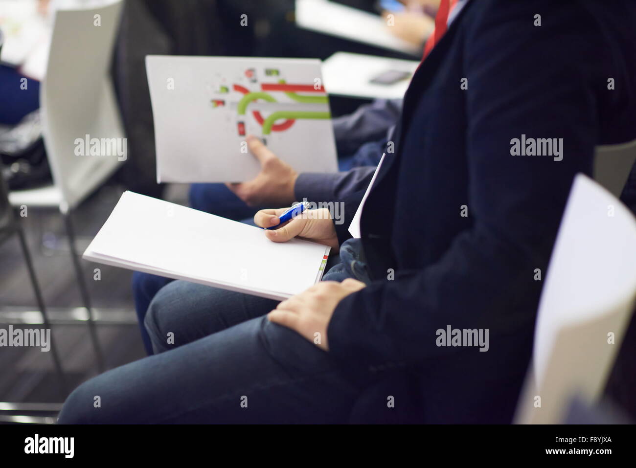 young business people taking notes on education training conference ...