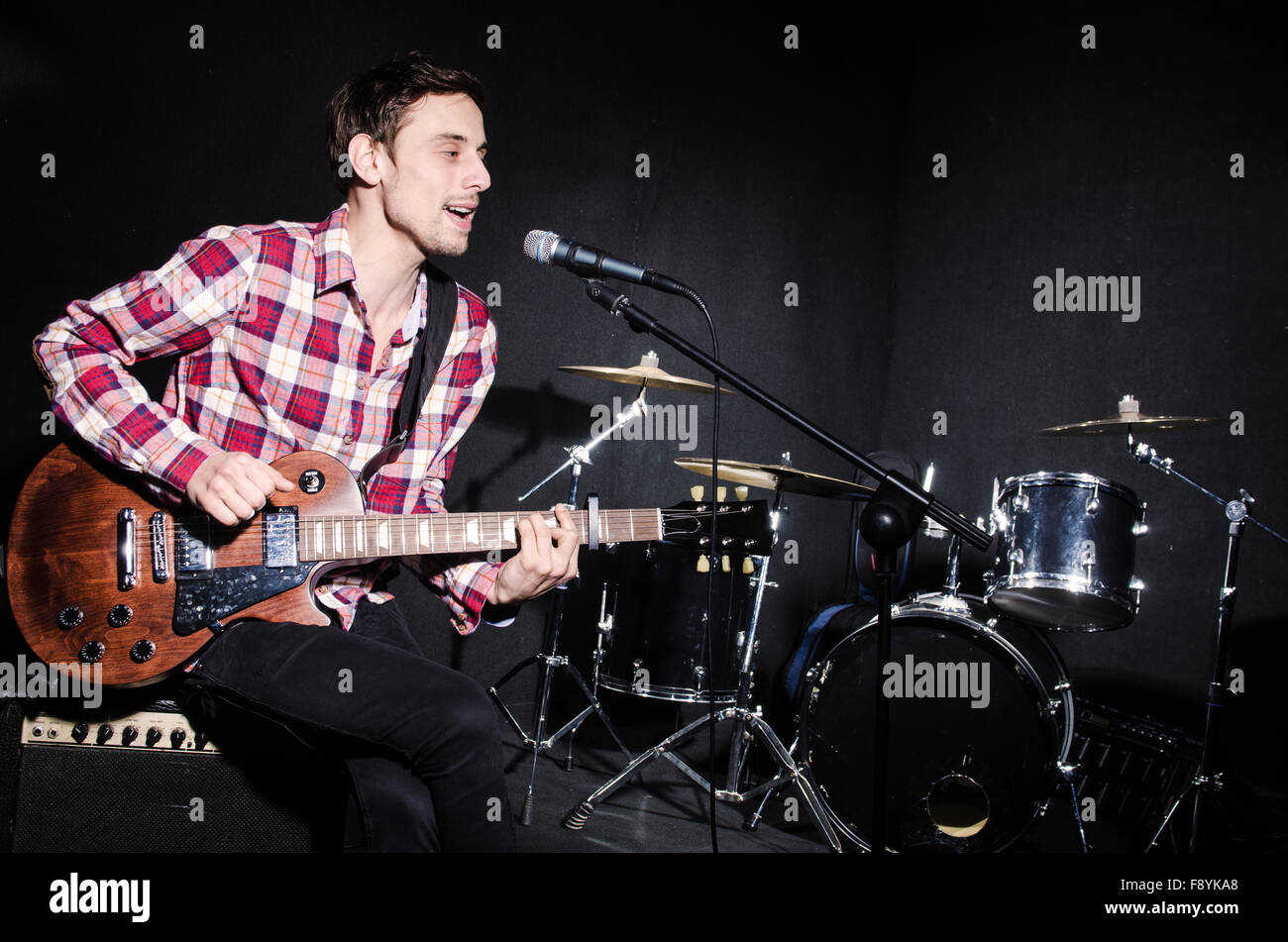 Man playing guitar during concert Stock Photo - Alamy