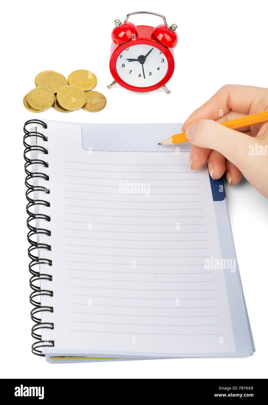 Hand writing in notebook with alarm clock Stock Photo - Alamy