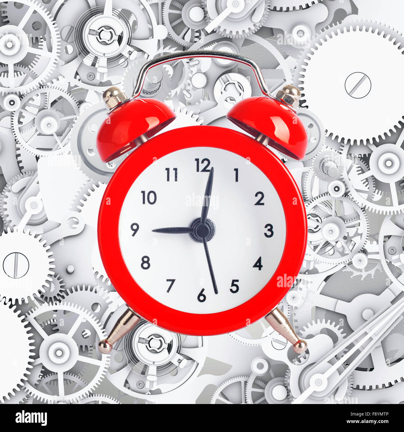 Alarm clock on metal cog gears background Stock Photo - Alamy