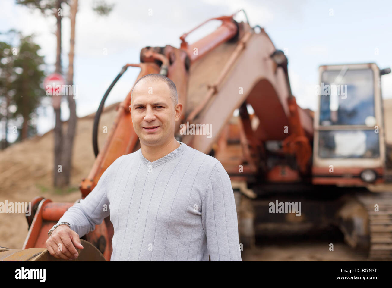 Portrait of tractor operator at sand pit Stock Photo - Alamy