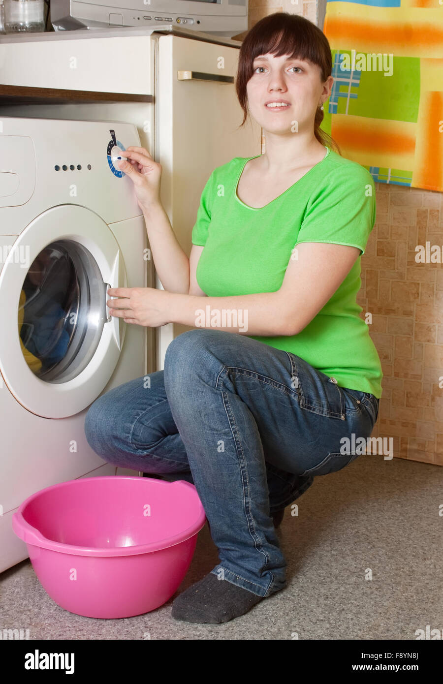 Beautiful women loading the washing machine. Cleaning and Laundry Stock ...