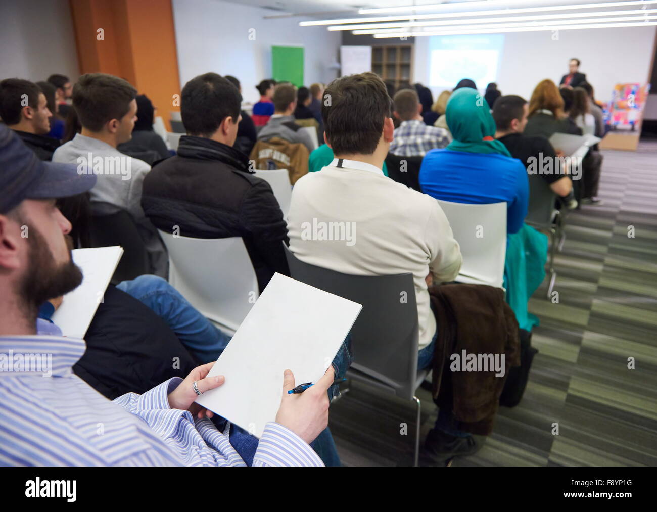young business people taking notes on education training conference ...