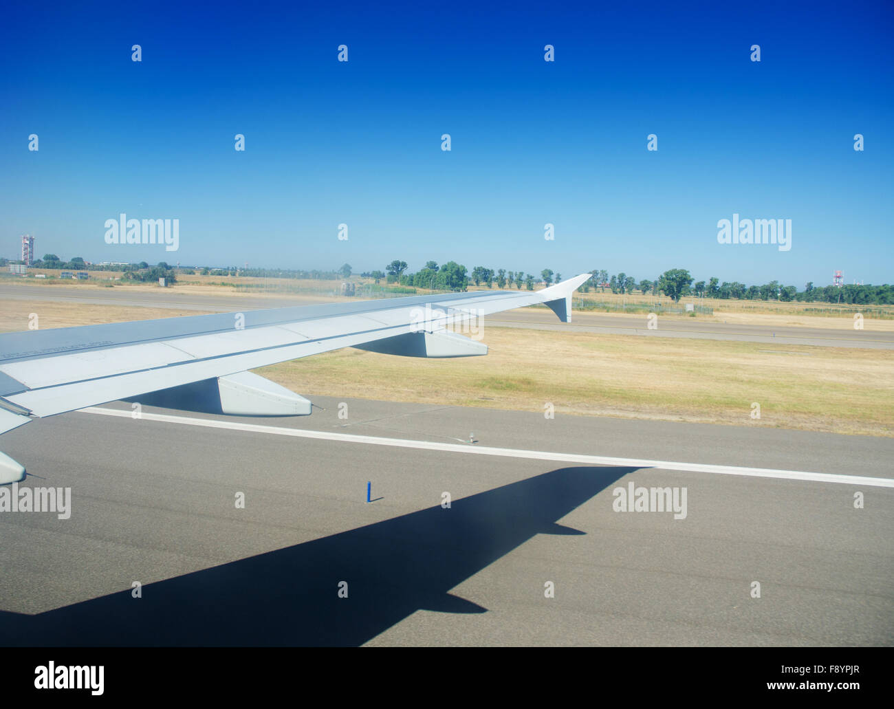 Airplane wing out of window Stock Photo - Alamy