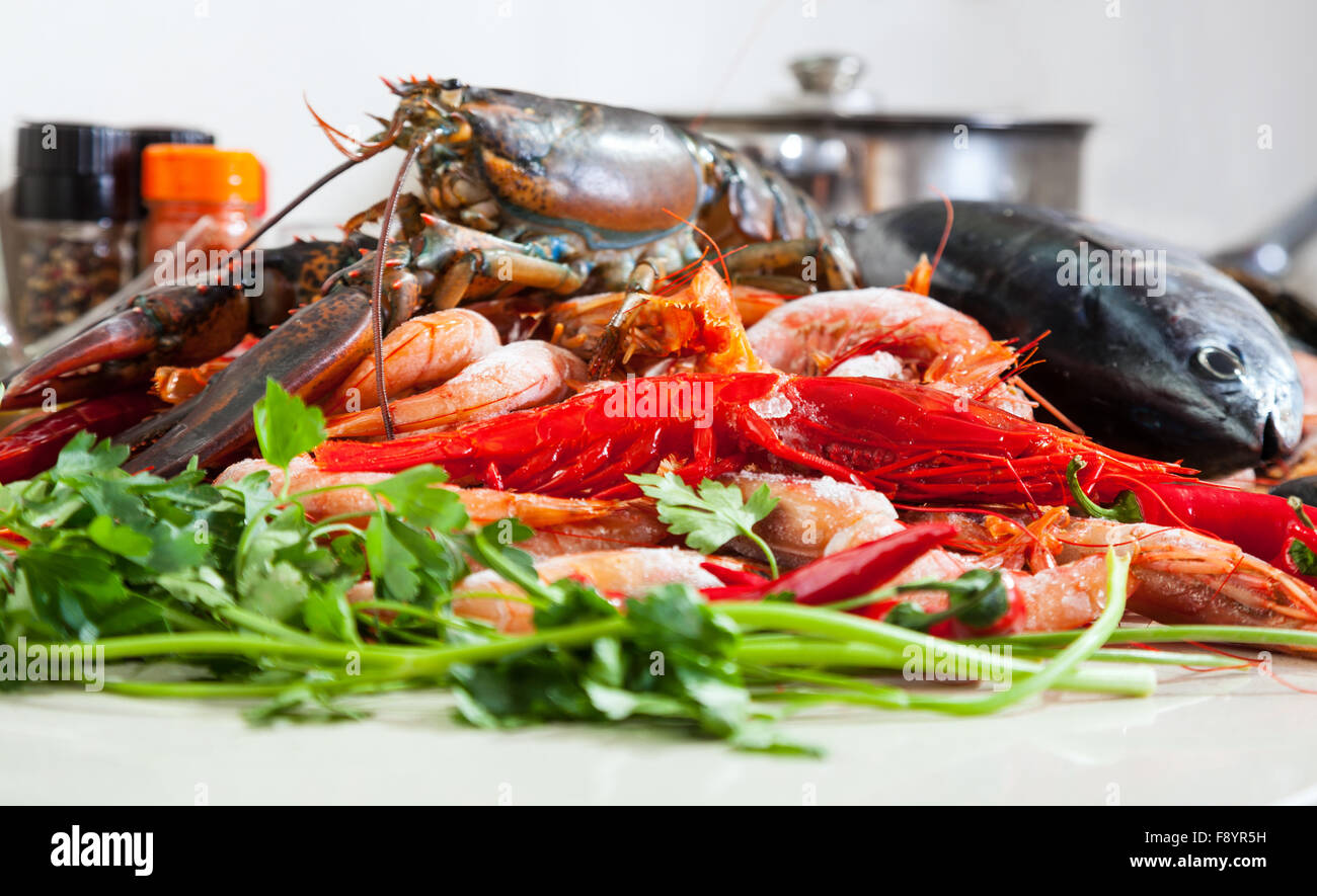 Fresh raw marine products at cooking table Stock Photo - Alamy
