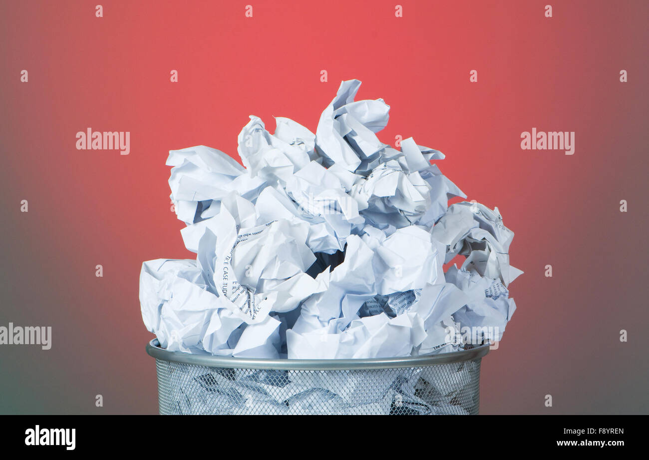 Garbage bin with paper waste against colourful background Stock Photo ...
