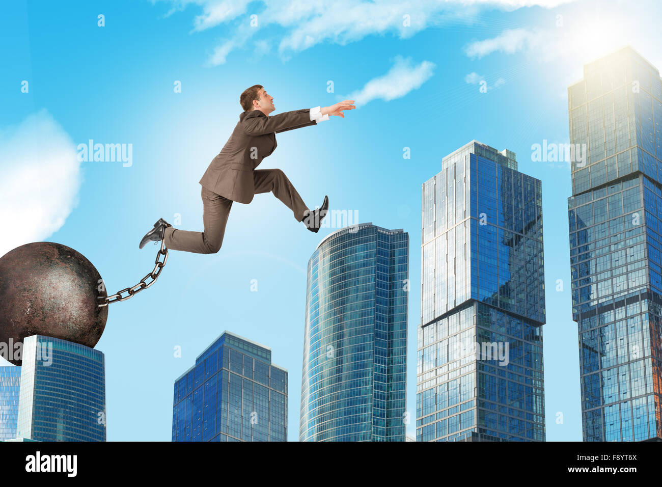 Young man in suit jumping over gap Stock Photo - Alamy