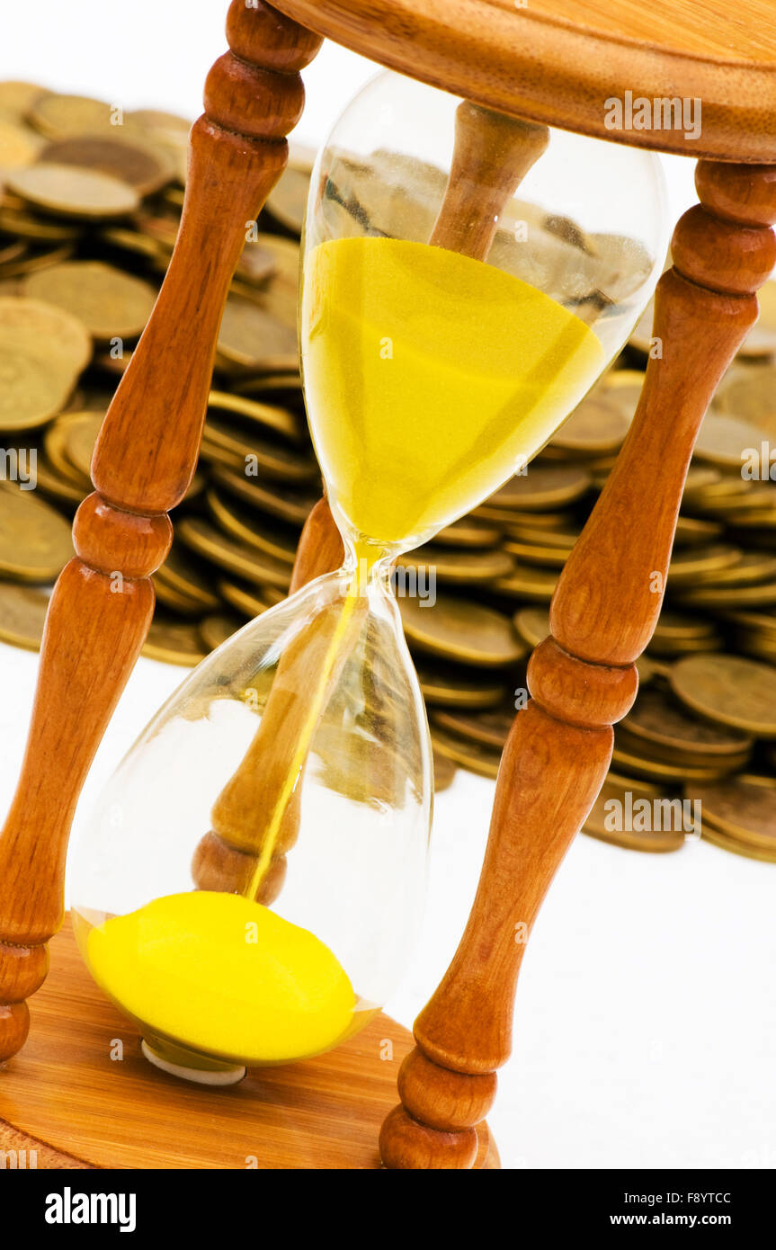 Time is money concept - hourglass and coins Stock Photo - Alamy