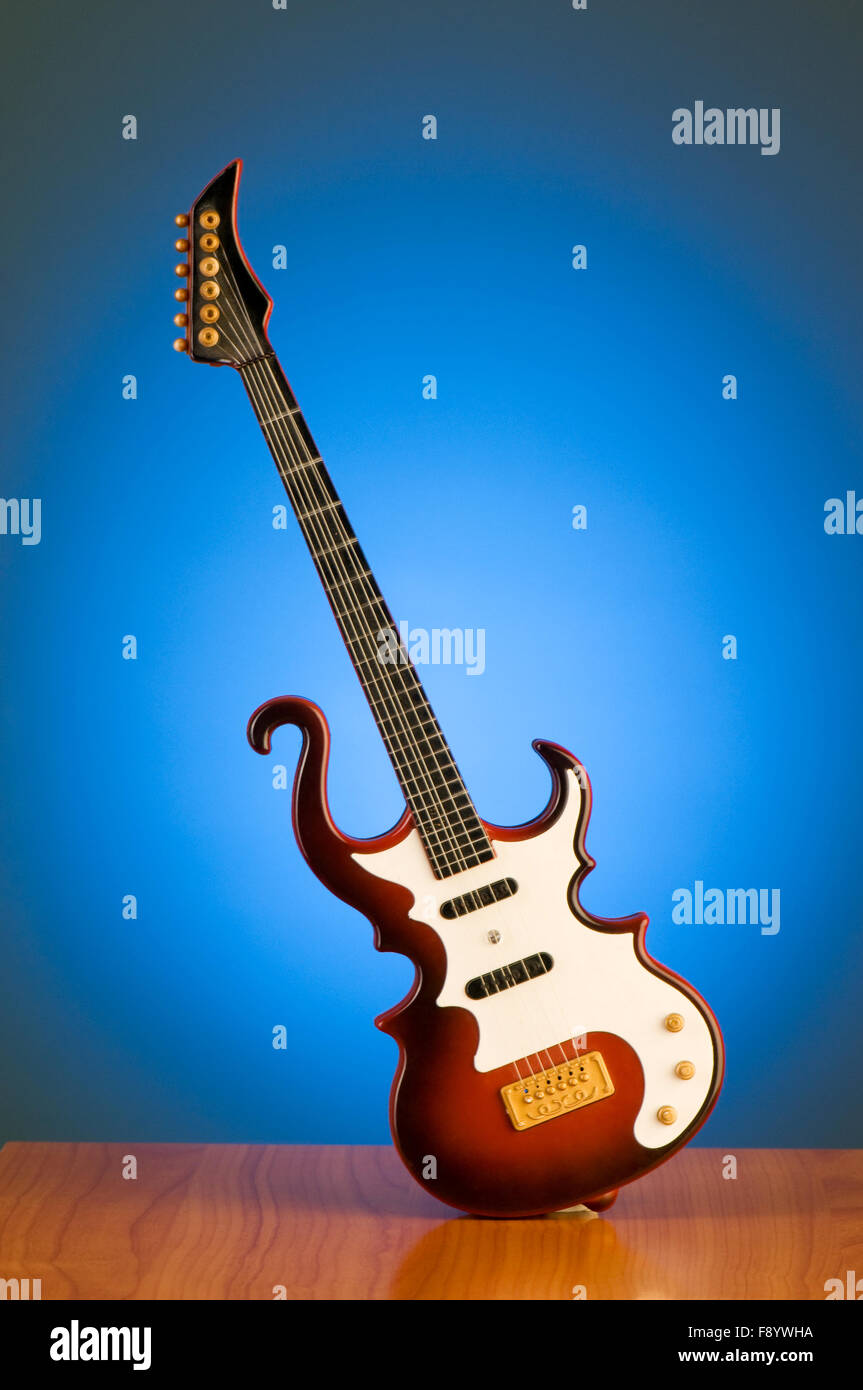 Wood guitar against gradient background Stock Photo - Alamy