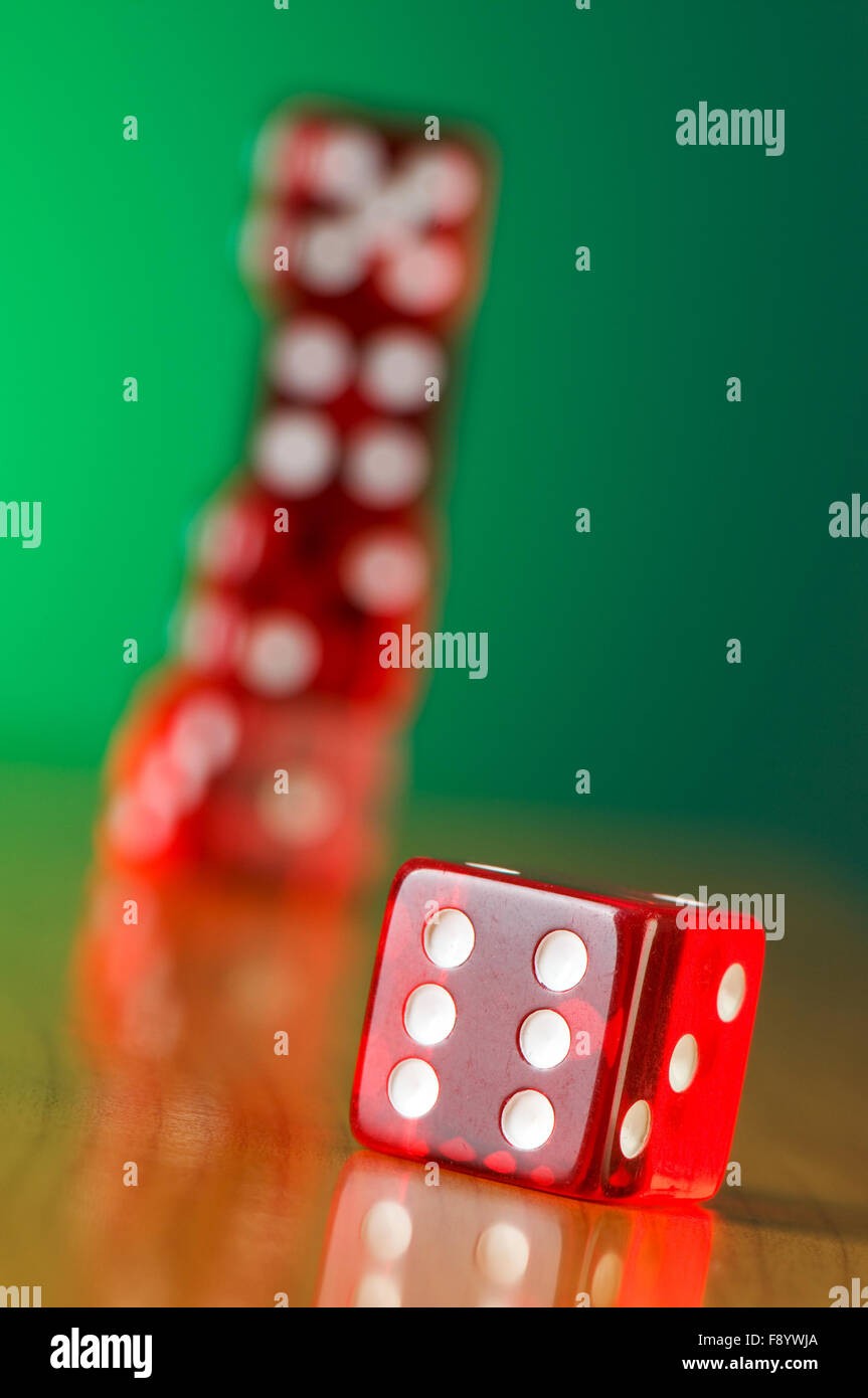 Stack of red casino dice against gradient background Stock Photo - Alamy