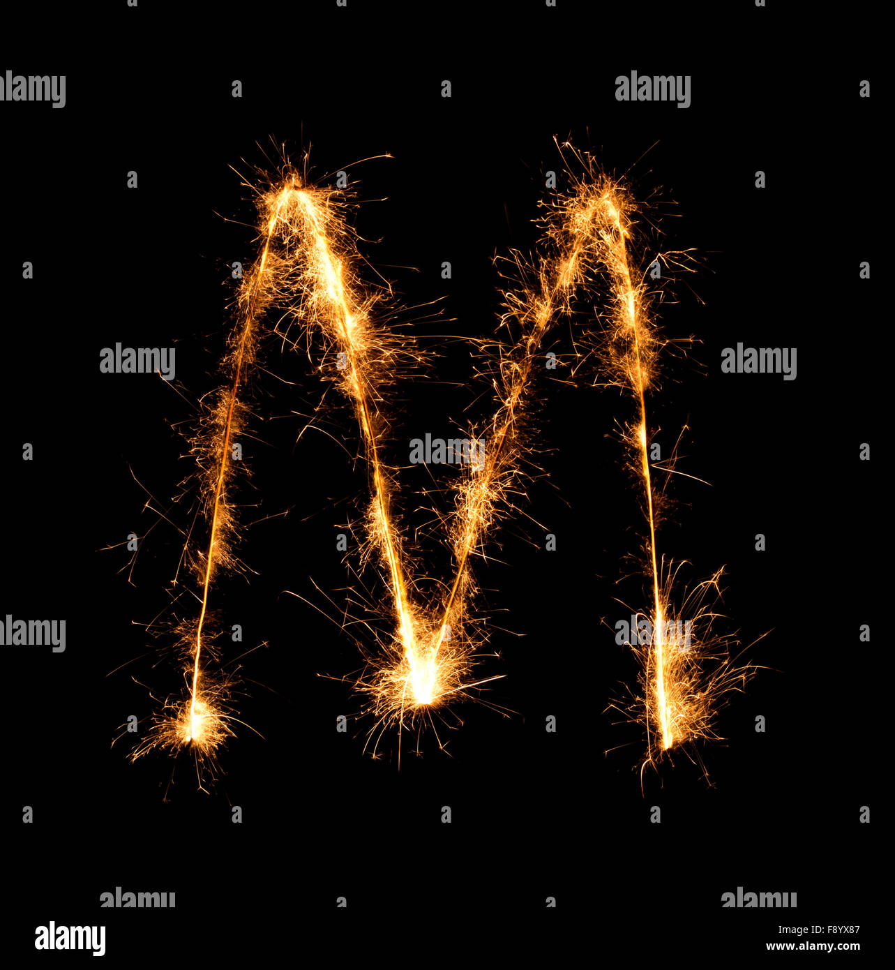 Sparkler firework light alphabet M (Capital Letters) at night ...