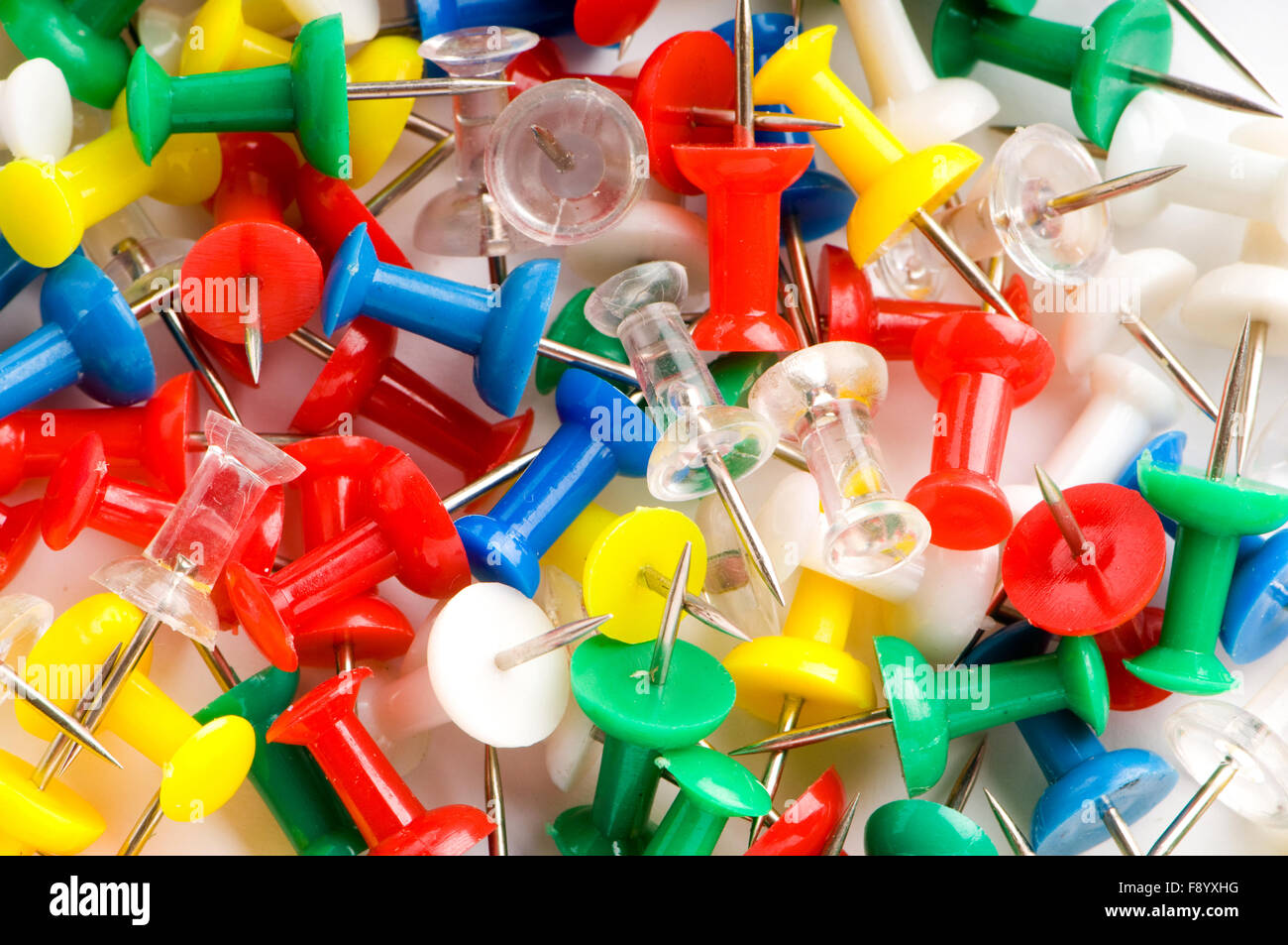 Many colourful office pins on the background Stock Photo - Alamy