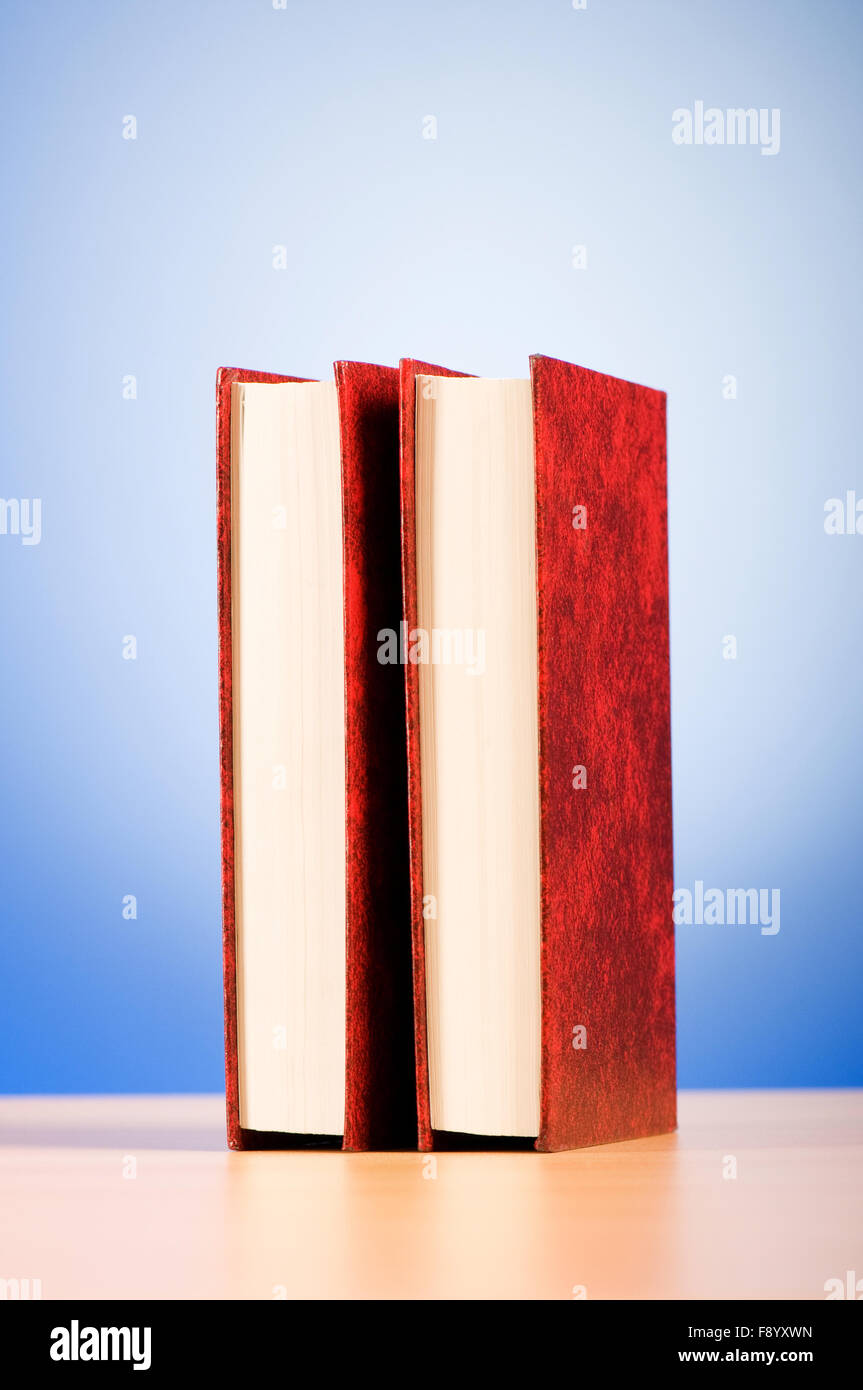 Stack of text books against gradient background Stock Photo - Alamy