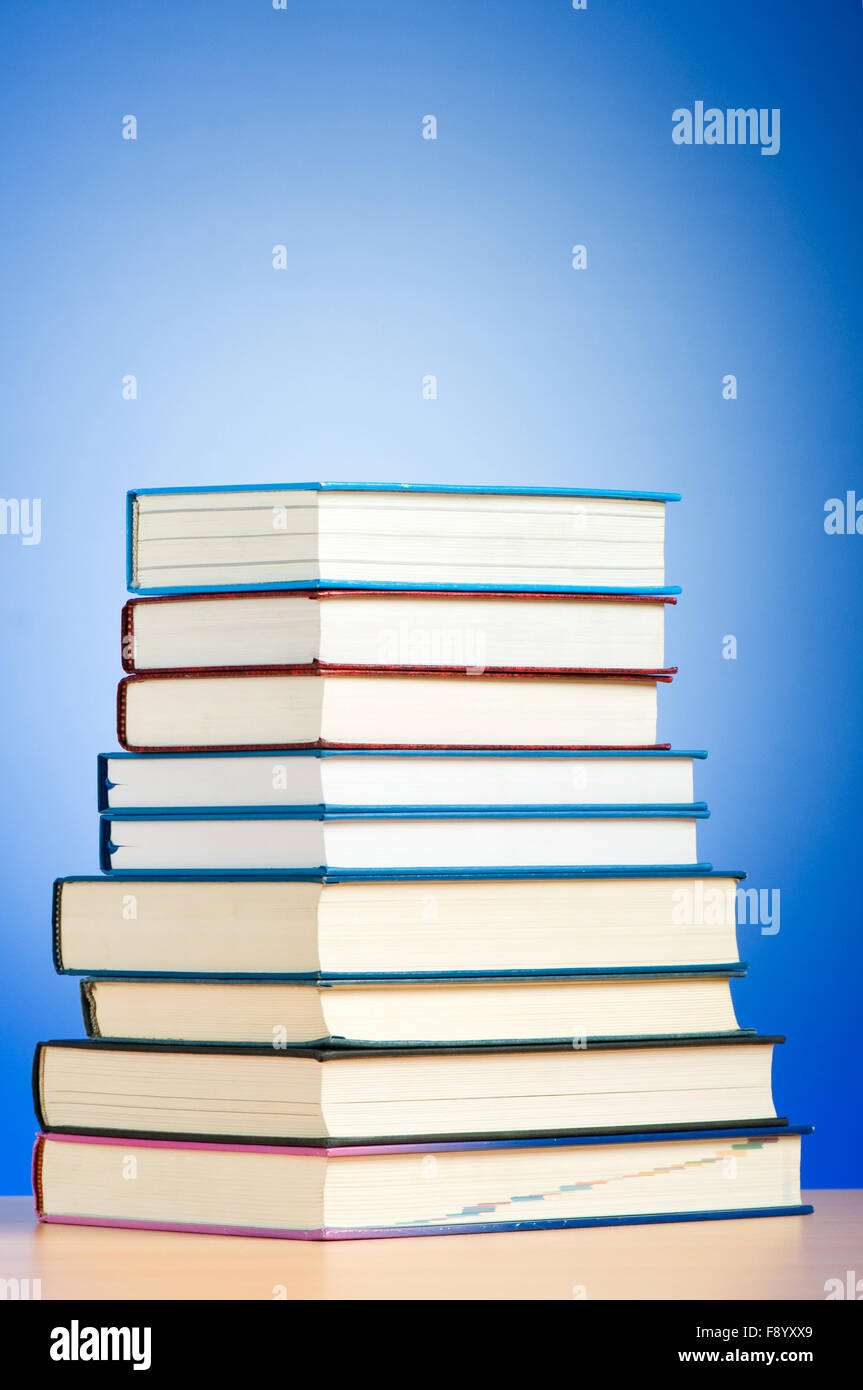Stack of text books against gradient background Stock Photo - Alamy