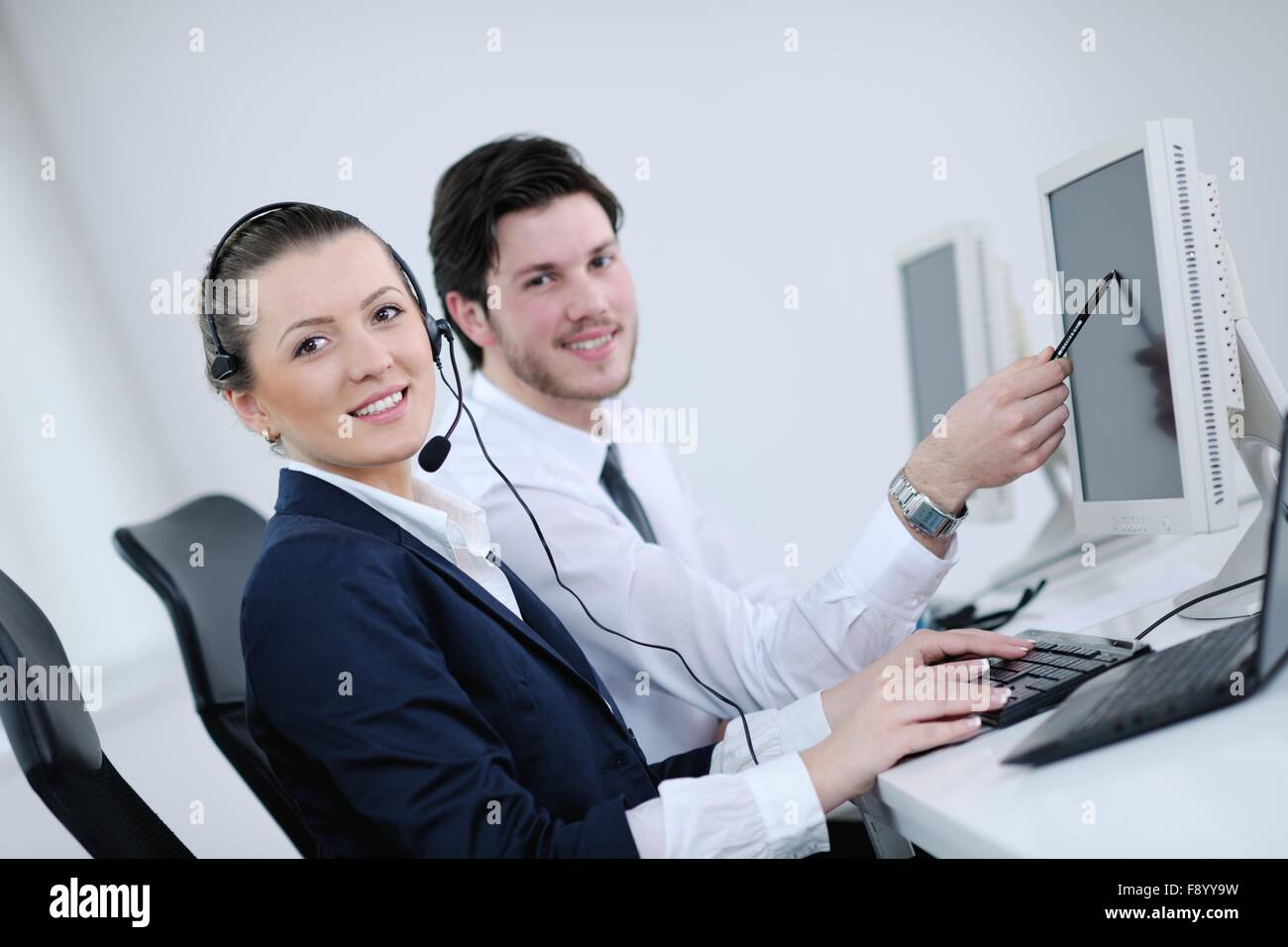 business people group with headphones giving support in help desk ...