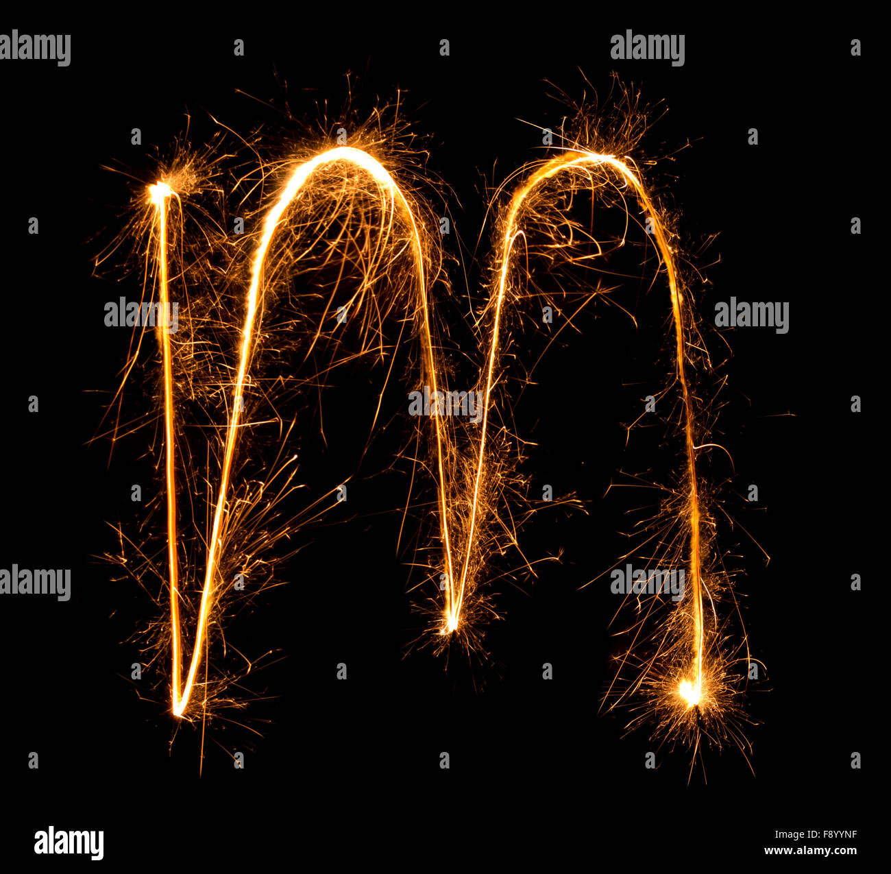 Sparkler firework light alphabet m (Small Letters) at night background ...