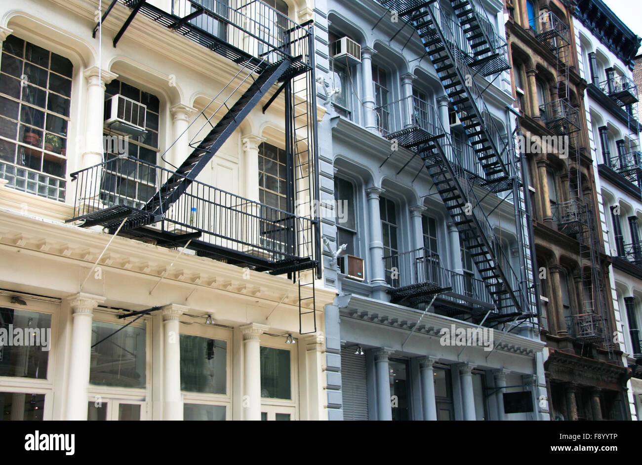 Three colorful, white blue and brown, apartment buildings facades with ...
