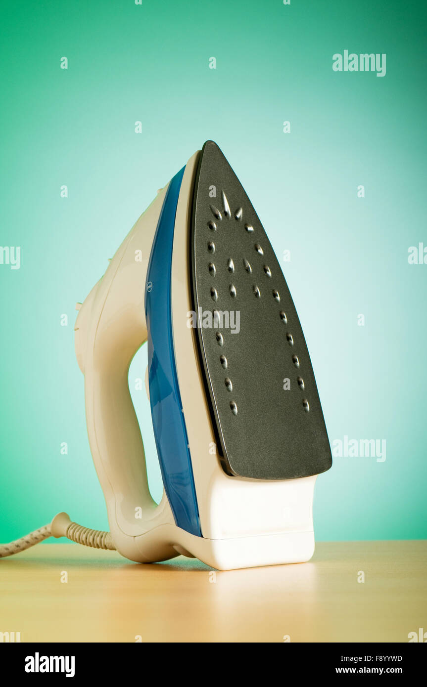 Modern electric iron against the colorful background Stock Photo - Alamy