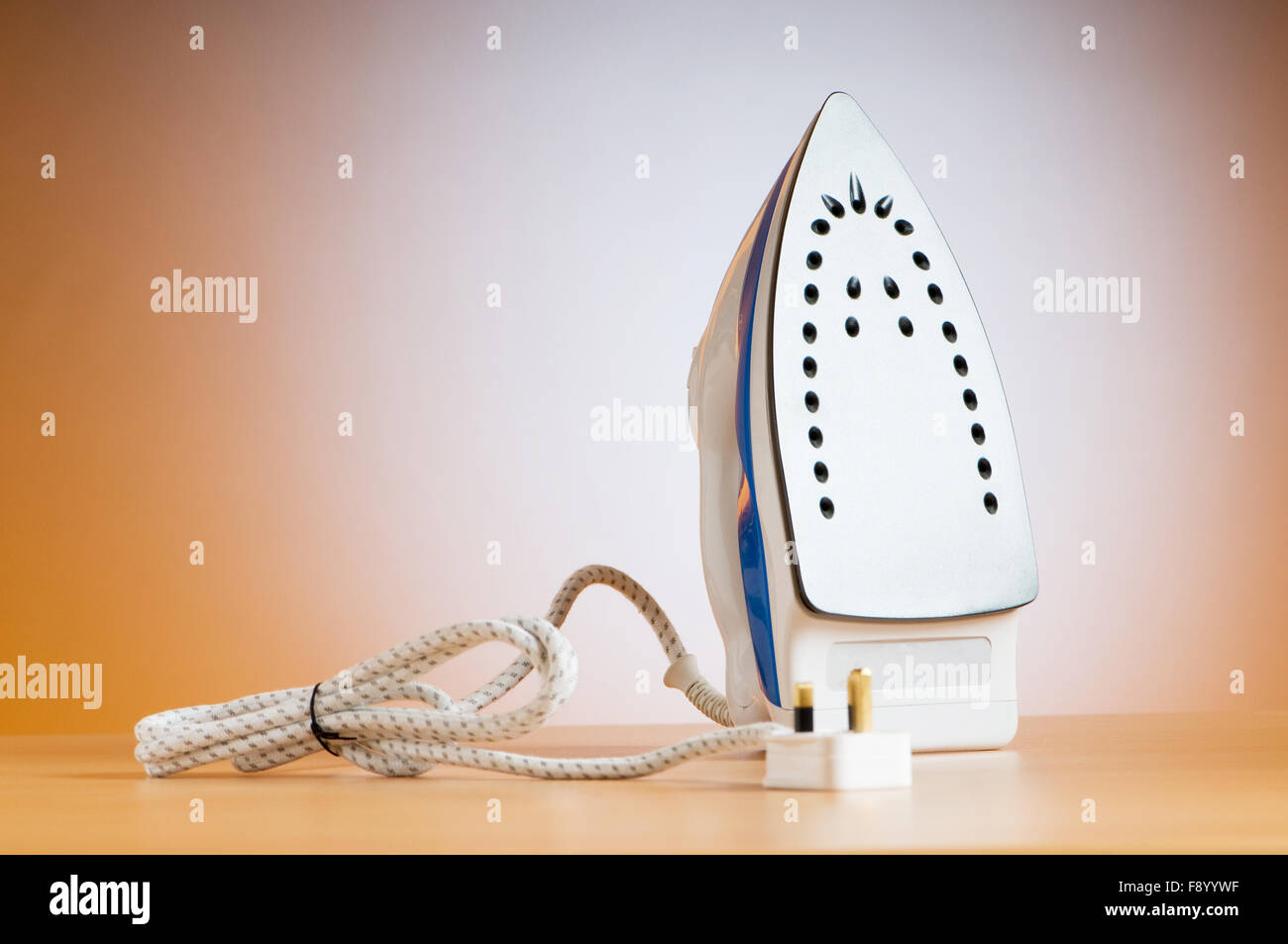 Modern electric iron against the colorful background Stock Photo - Alamy