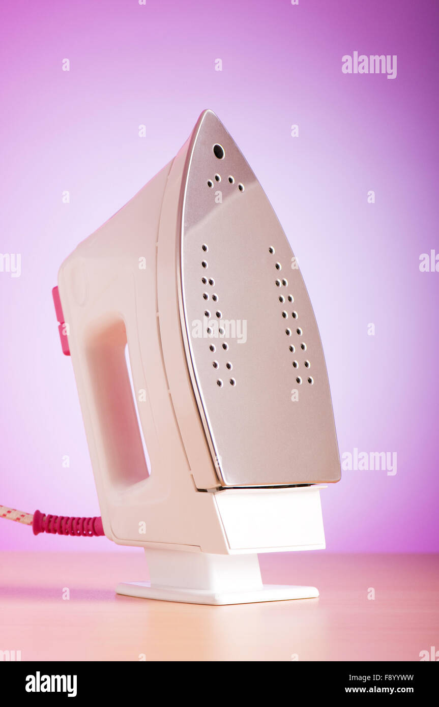 Modern electric iron against the colorful background Stock Photo - Alamy