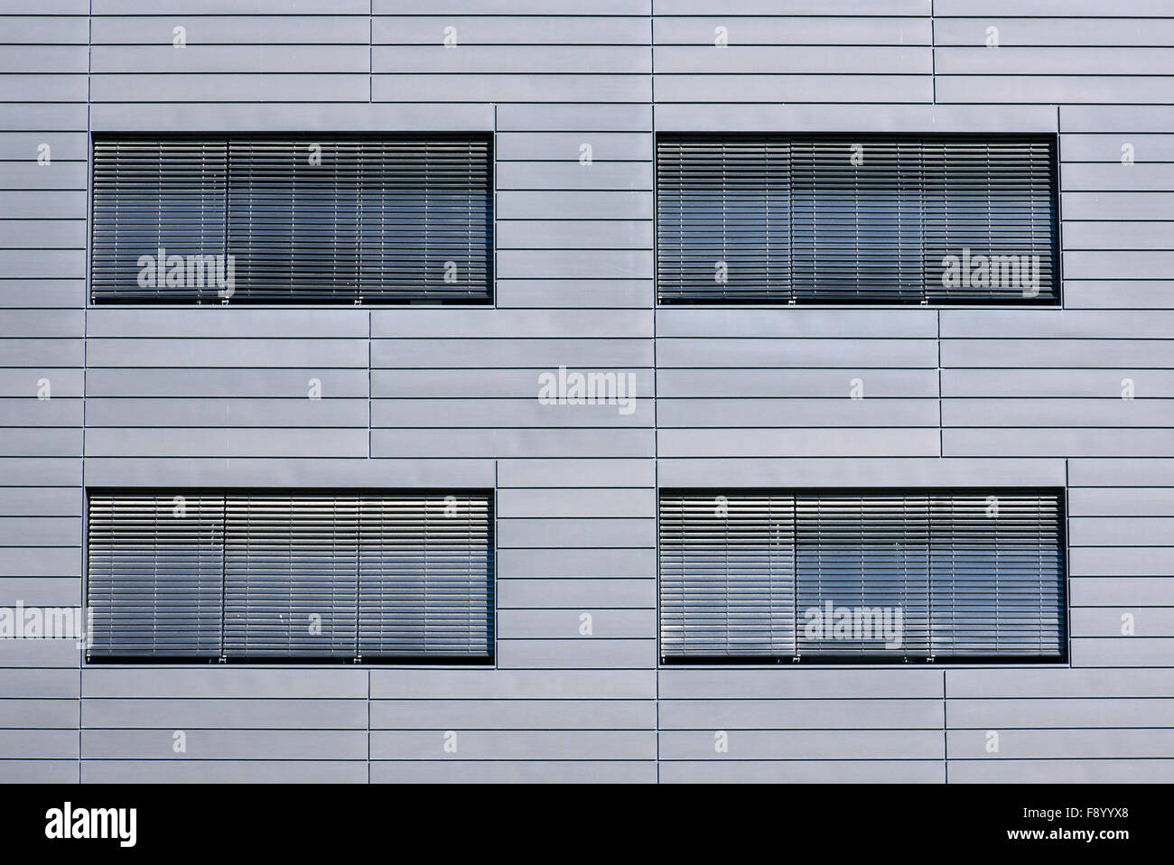Windows with jalousies of a grey building Stock Photo - Alamy