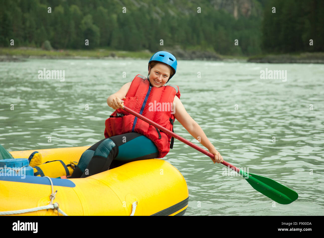 Girl with a paddle on the raft Stock Photo - Alamy