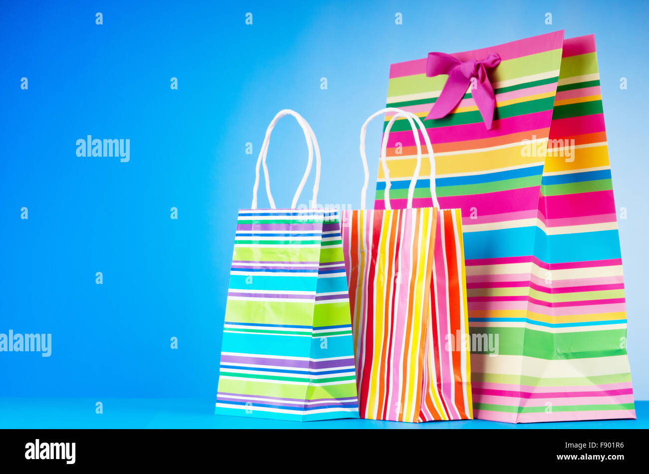 Colourful paper shopping bags against gradient background Stock Photo ...
