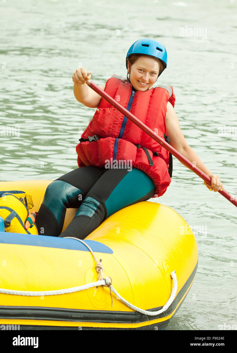Girl with a paddle on the raft Stock Photo - Alamy