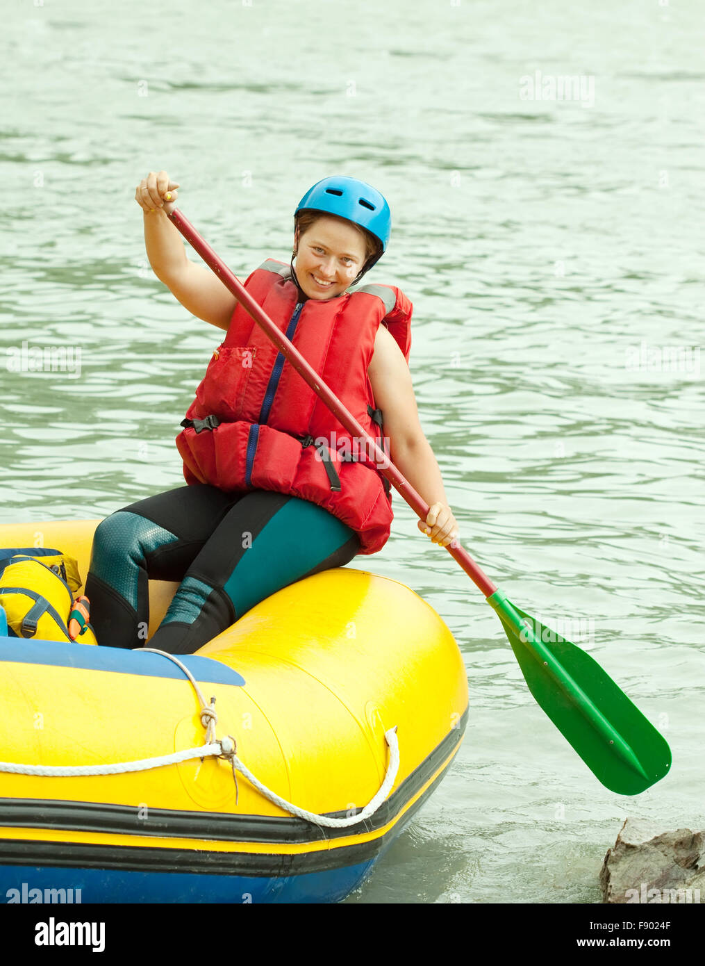 Girl with a paddle on the raft Stock Photo - Alamy