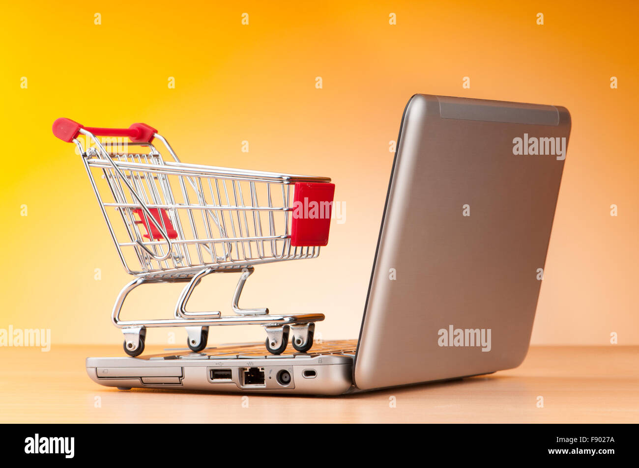 Internet online shopping concept with computer and cart Stock Photo - Alamy