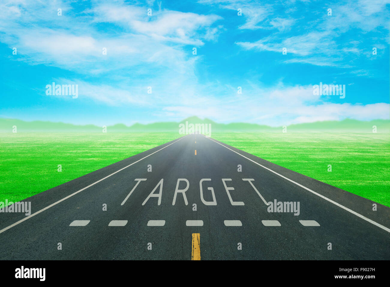 empty road through the green field with sign target on asphalt Stock ...