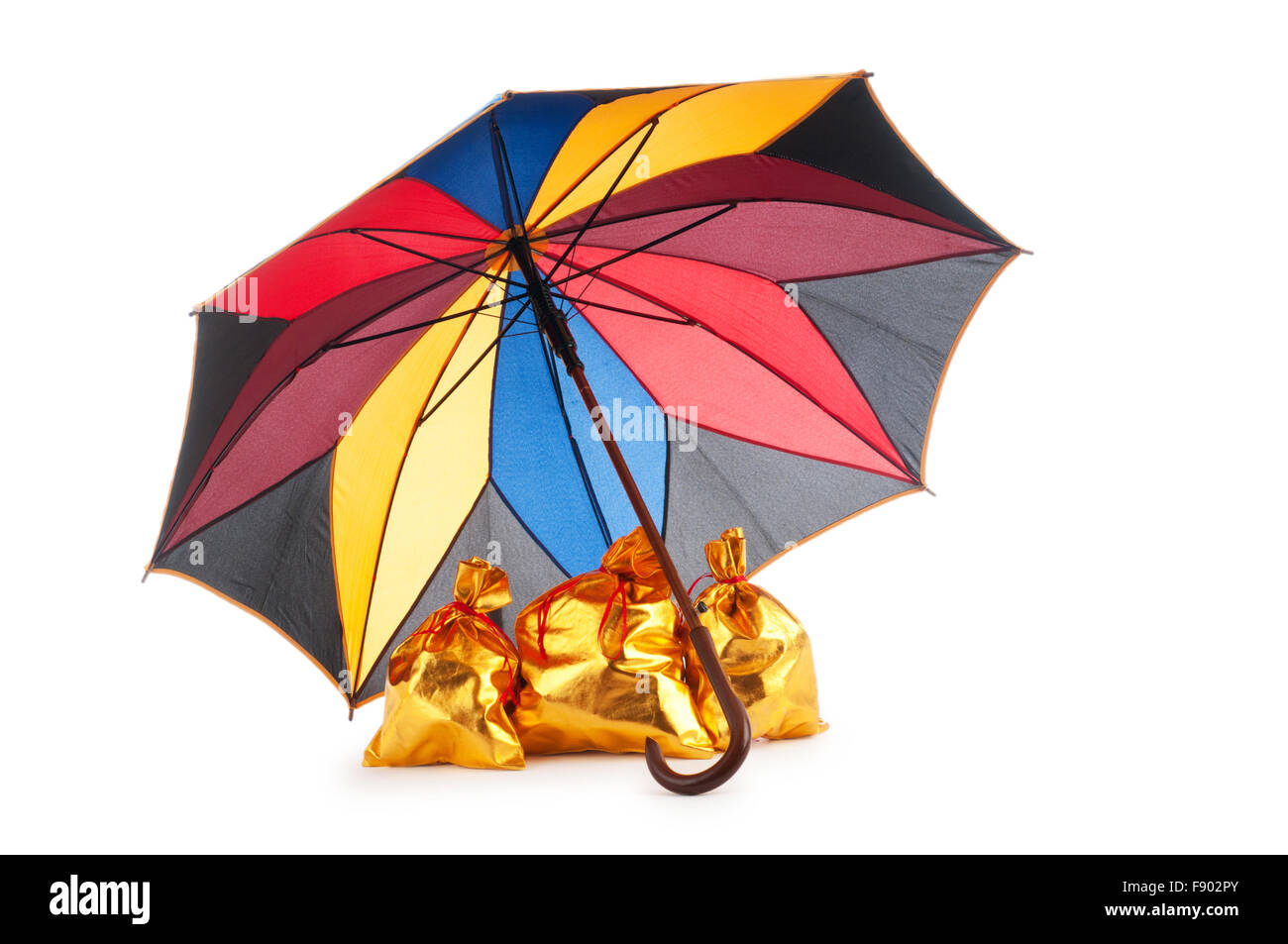 Golden sacks under protection of umbrella Stock Photo - Alamy