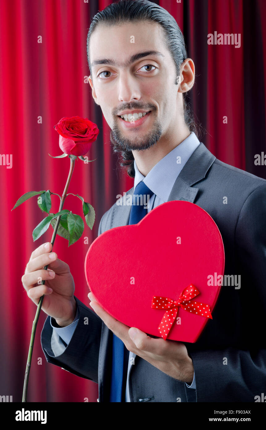 Young man with red rose Stock Photo - Alamy