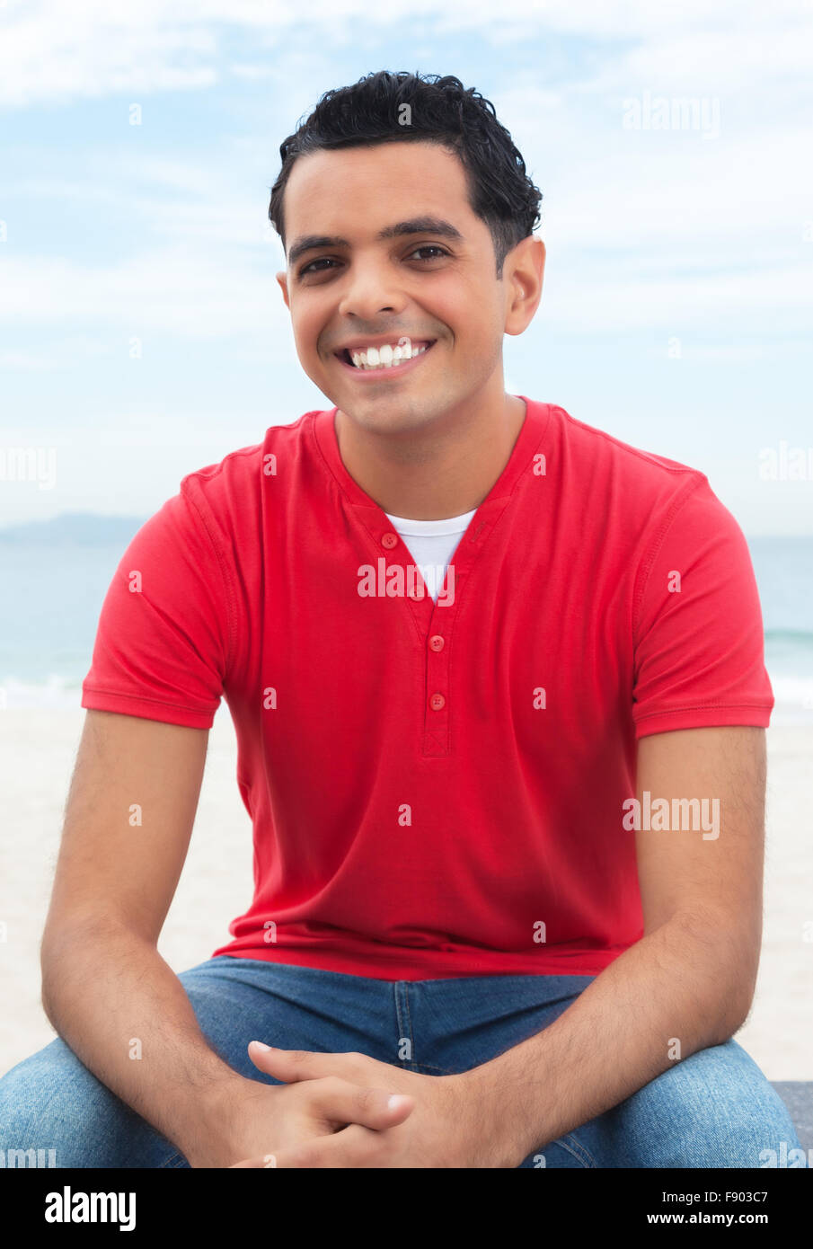 Handsome latin guy at beach looking at camera Stock Photo - Alamy
