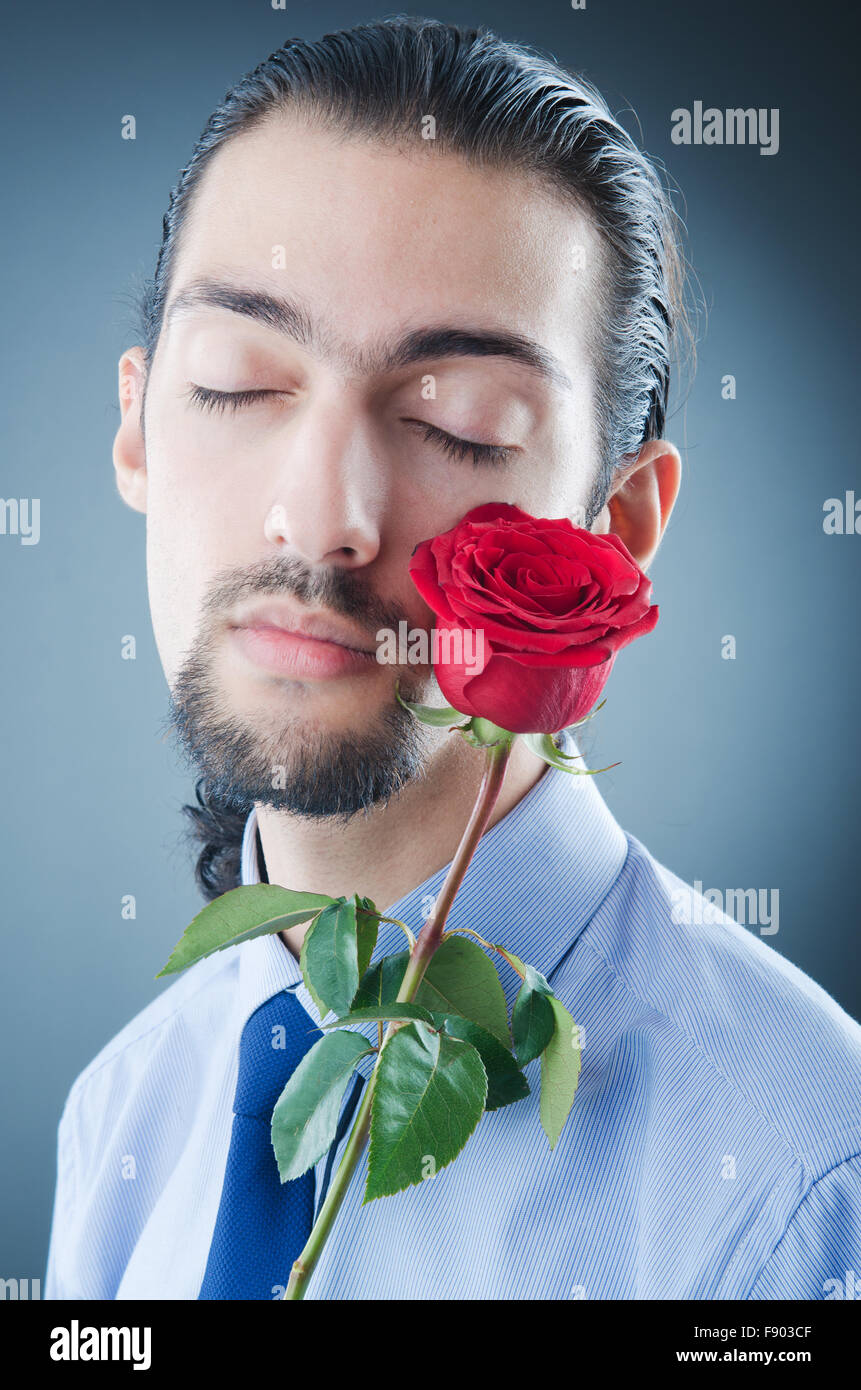 Young man with red rose Stock Photo - Alamy