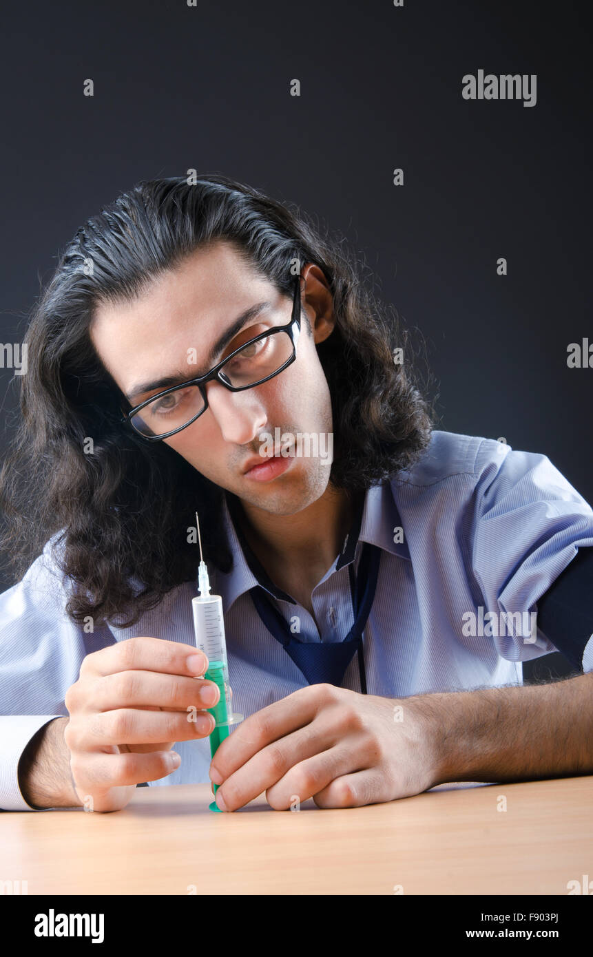 Young druc addict with syringe Stock Photo - Alamy