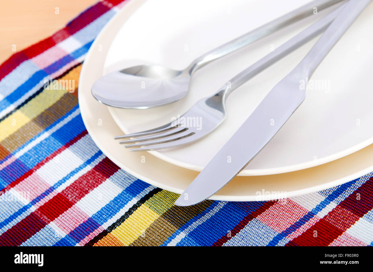 Empty plate with utensils Stock Photo - Alamy