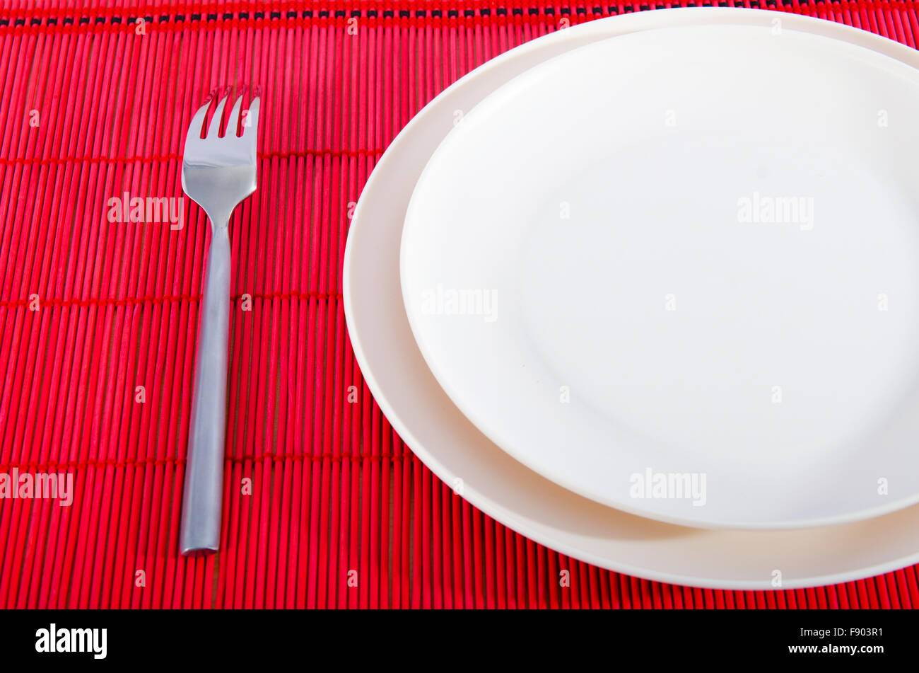 Empty plate with utensils Stock Photo - Alamy