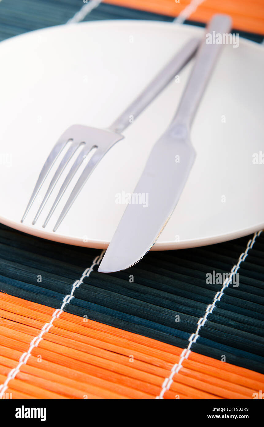 Empty plate with utensils Stock Photo - Alamy