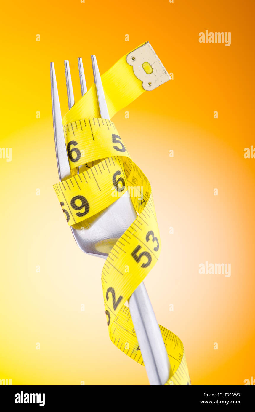 Dieting concept with fork and meter Stock Photo - Alamy