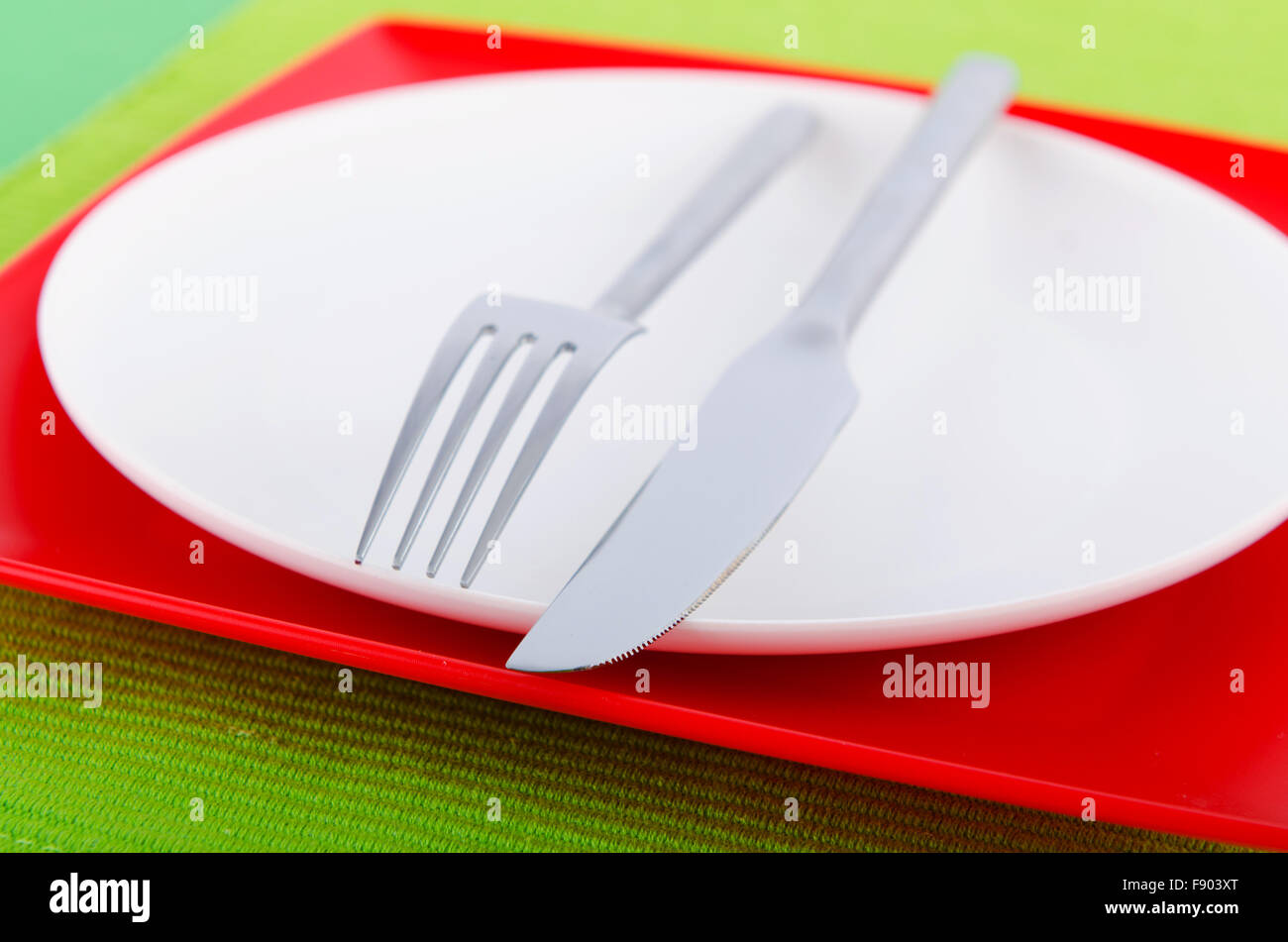 Empty plate with utensils Stock Photo - Alamy