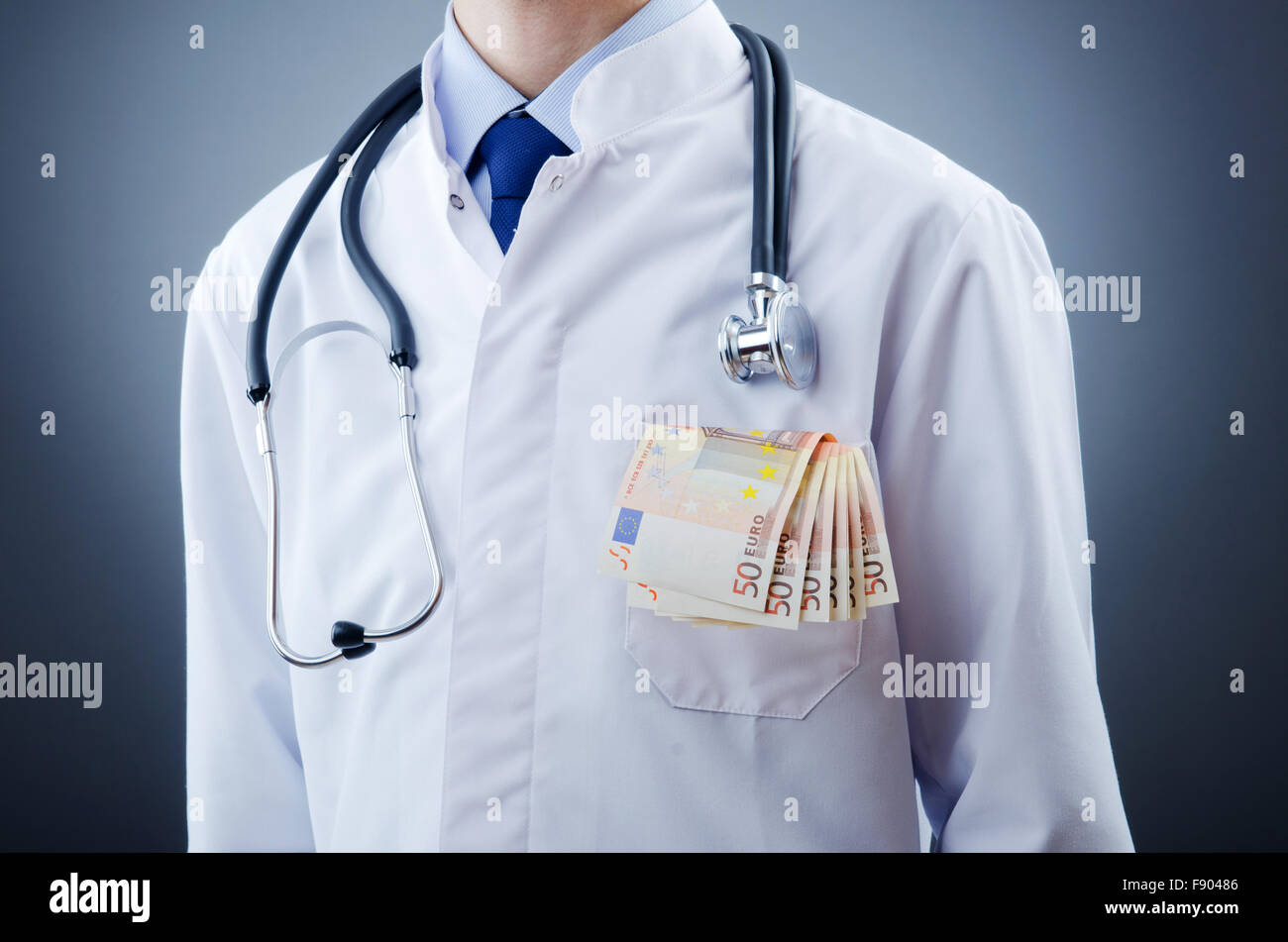 Doctor with money in studio Stock Photo - Alamy