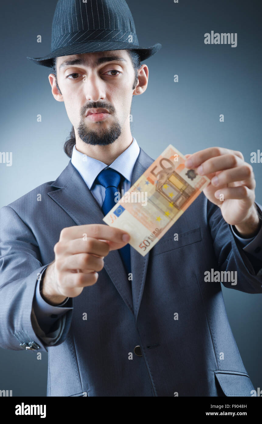 Detective looking at fake money Stock Photo - Alamy