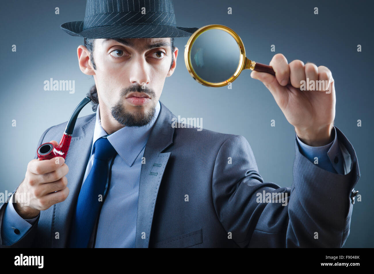 Detective with the smoking pipe Stock Photo - Alamy